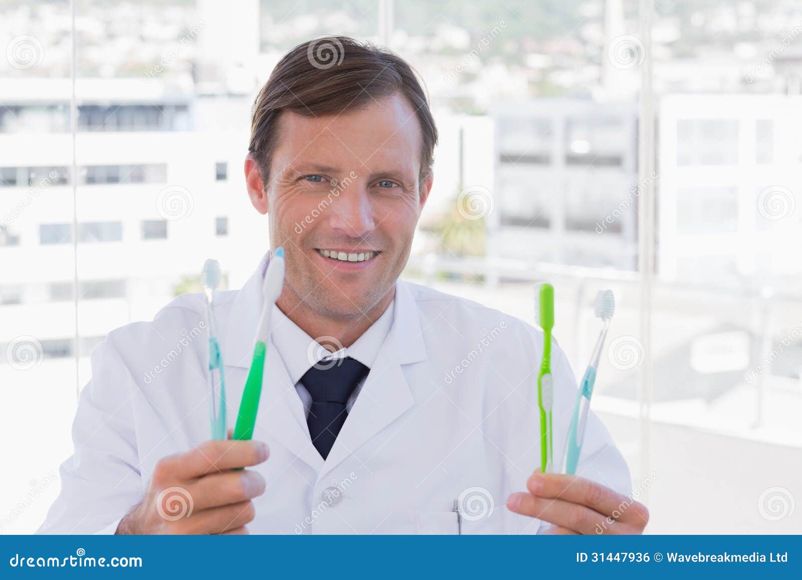 Happy Doctor Holding Two Toothbrushes Stock Photo - Image of ...