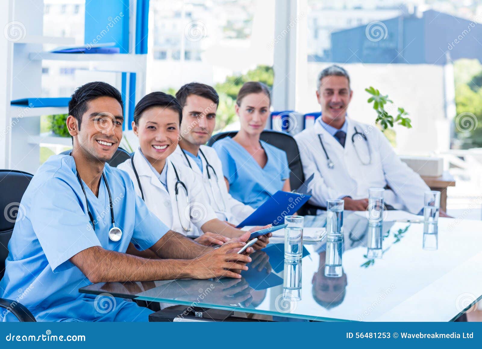 Happy Doctors Looking at Camera while Sitting at a Table Stock Image ...