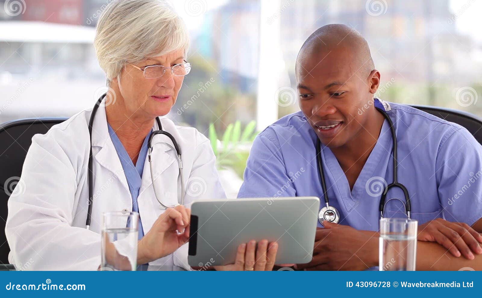 Happy Doctors Working with a Touchscreen Stock Footage - Video of ...