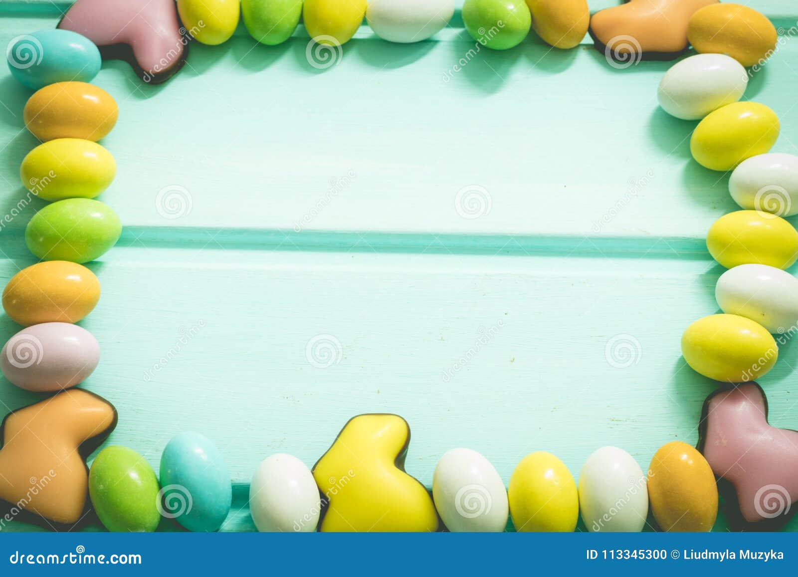 Happy Easter. Colorful Candy Eggs and Chocolate Rabbits on Blue ...