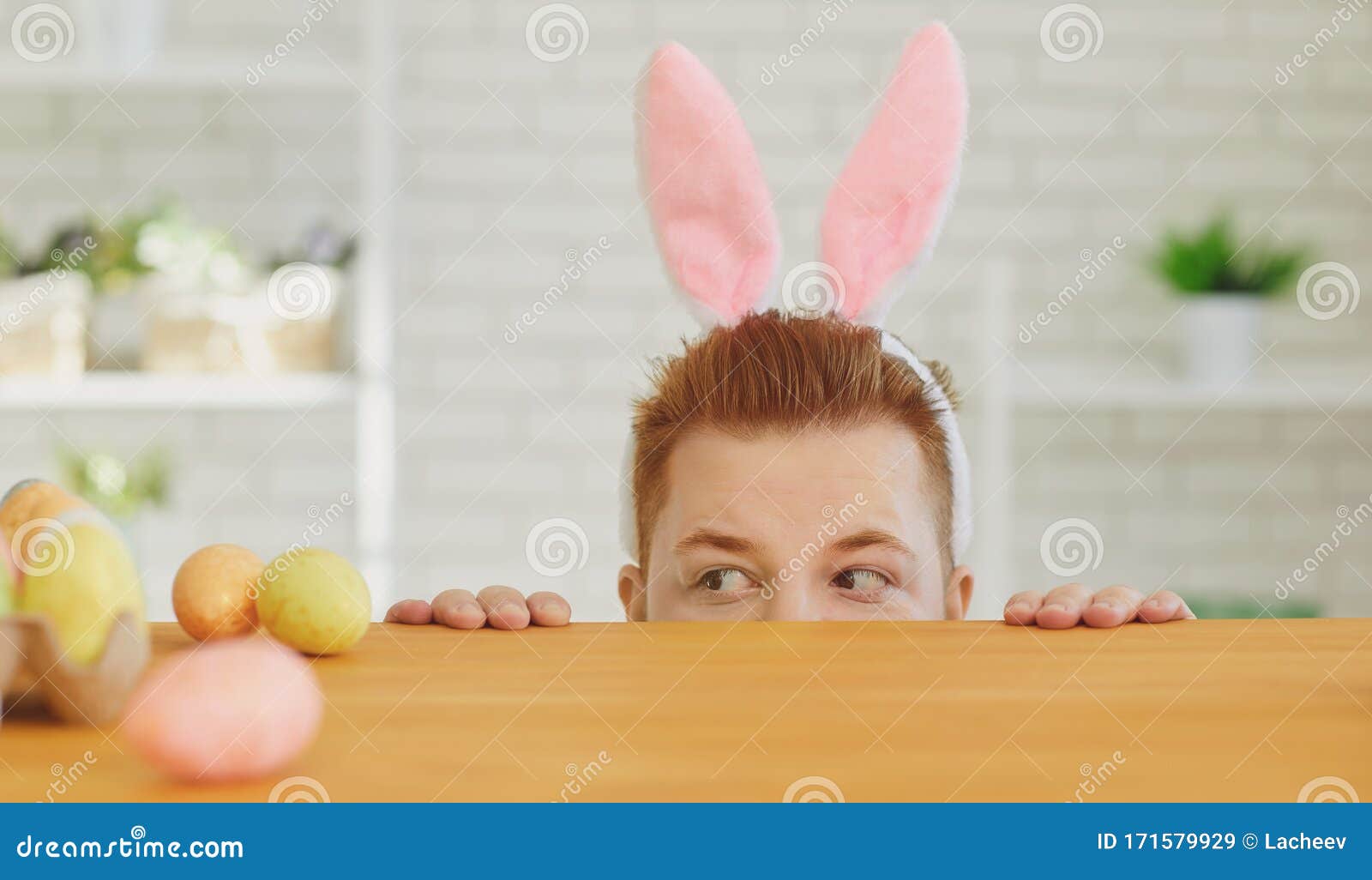 Happy Easter.A Funny Fat Man Decorates Eggs While Sitting At A Table ...