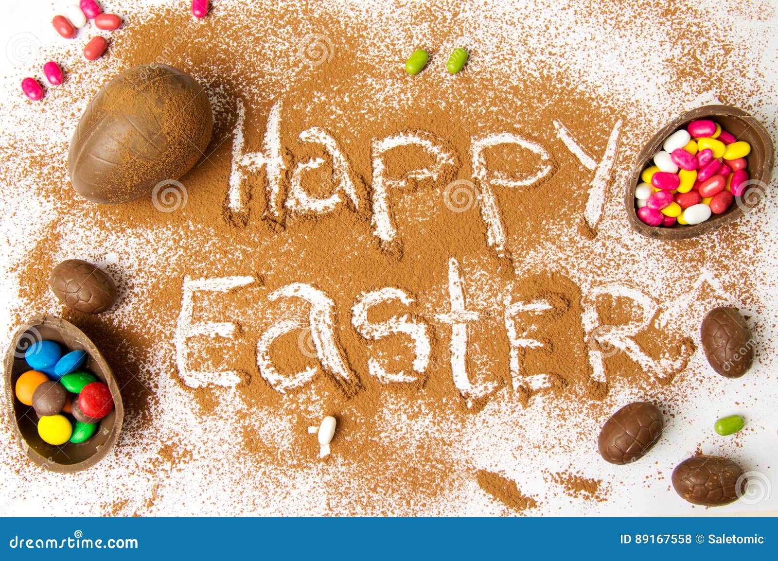 Happy Easter Note in Cacao Powder with Chocolate Eggs Stock Photo ...