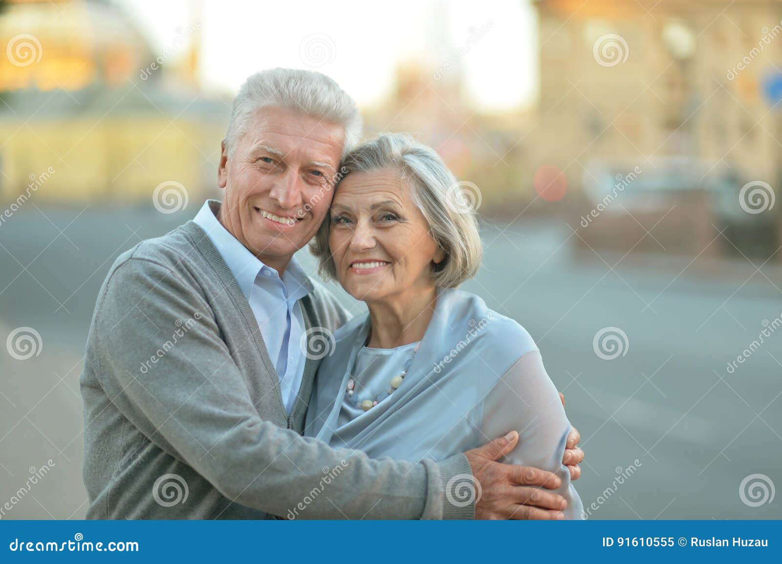 Happy Elderly Couple Embracing Stock Image - Image of smiling, street ...