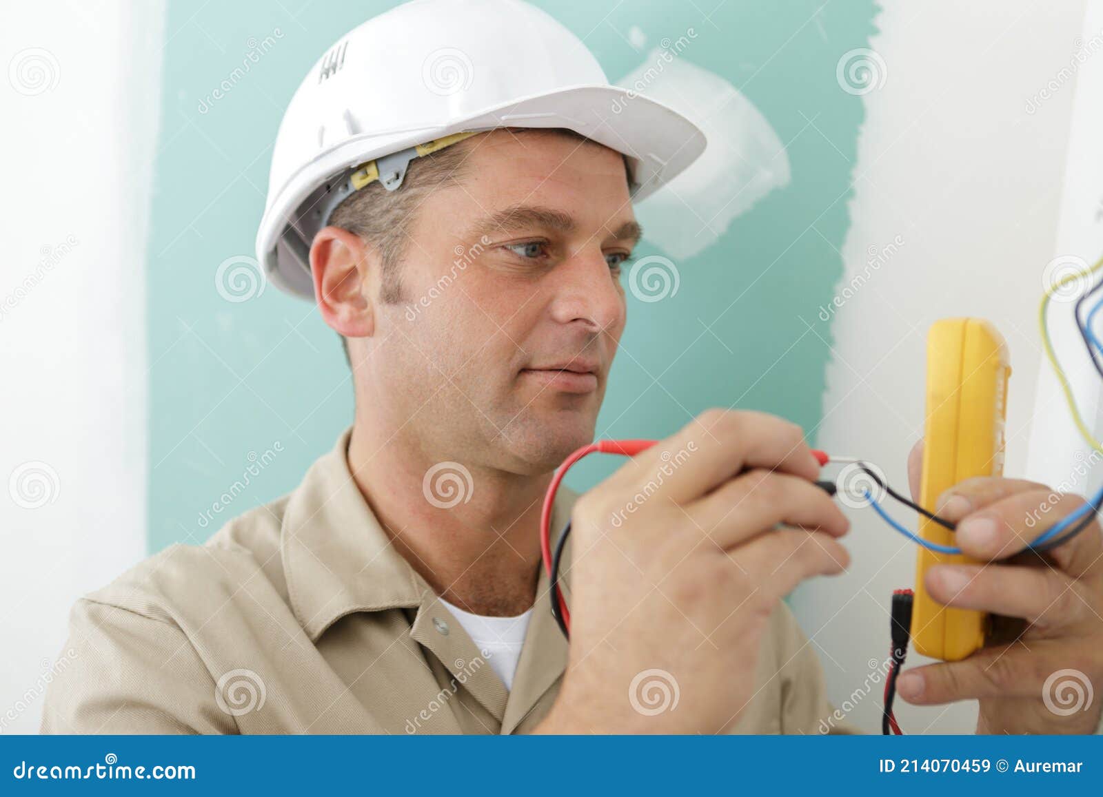 Happy Electrician Checking Voltage in Electrical Wall Socket Stock ...
