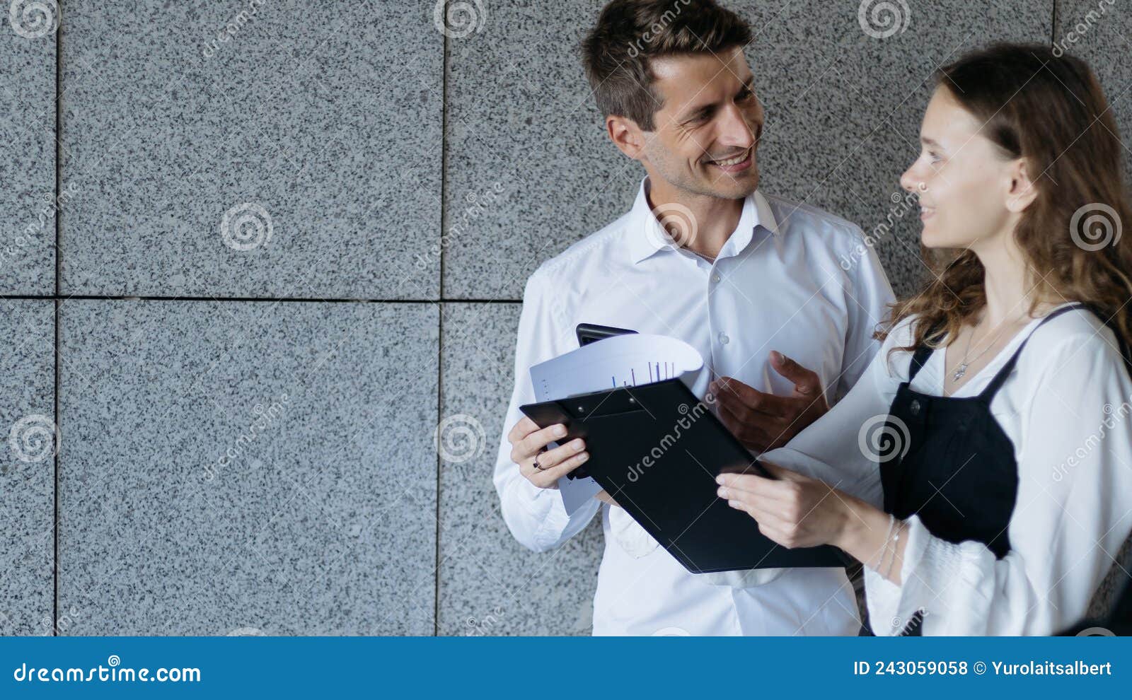 Happy Employees Reading a Document while Standing on the Steps in the ...