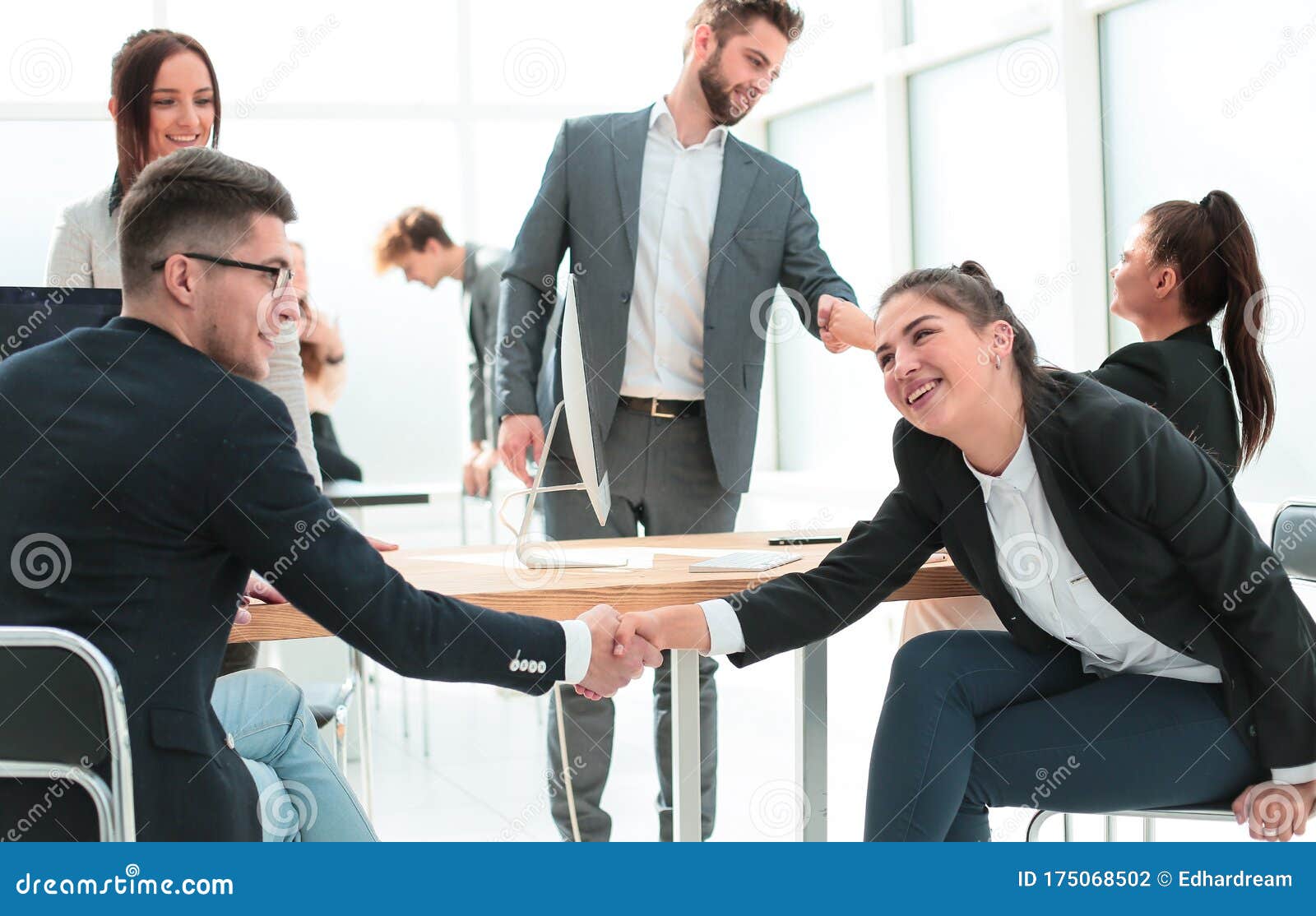 Happy Employees Shaking Hands in the Workplace. Stock Photo - Image of ...