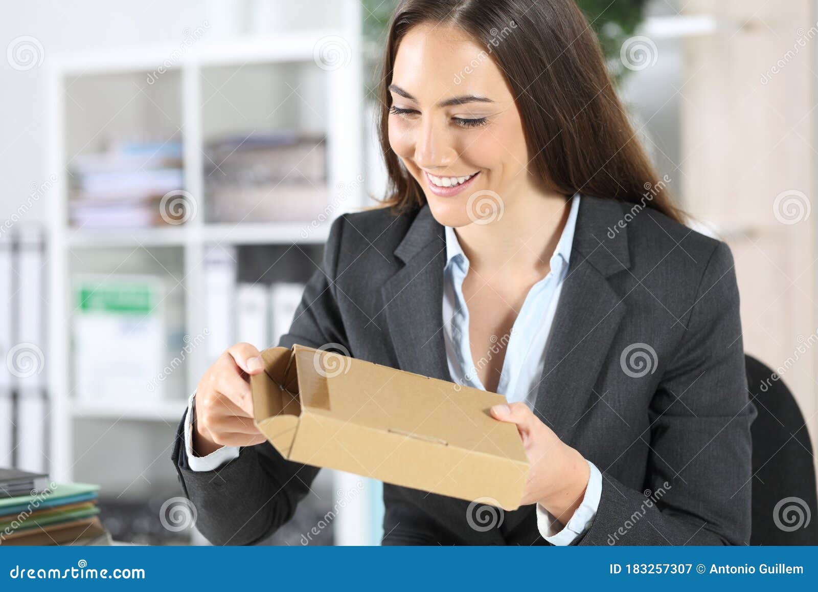 Happy Executive Opening Package Sitting at Office Stock Image - Image ...