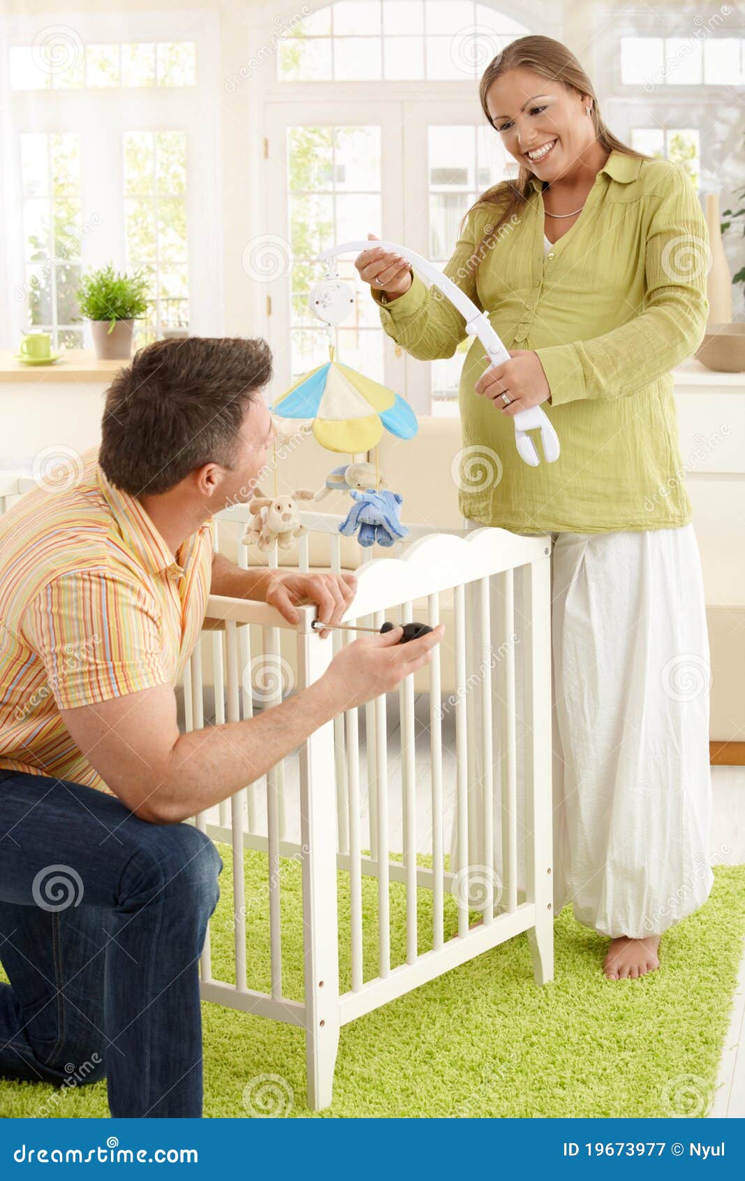 Happy expectant couple stock image. Image of concentrating - 19673977