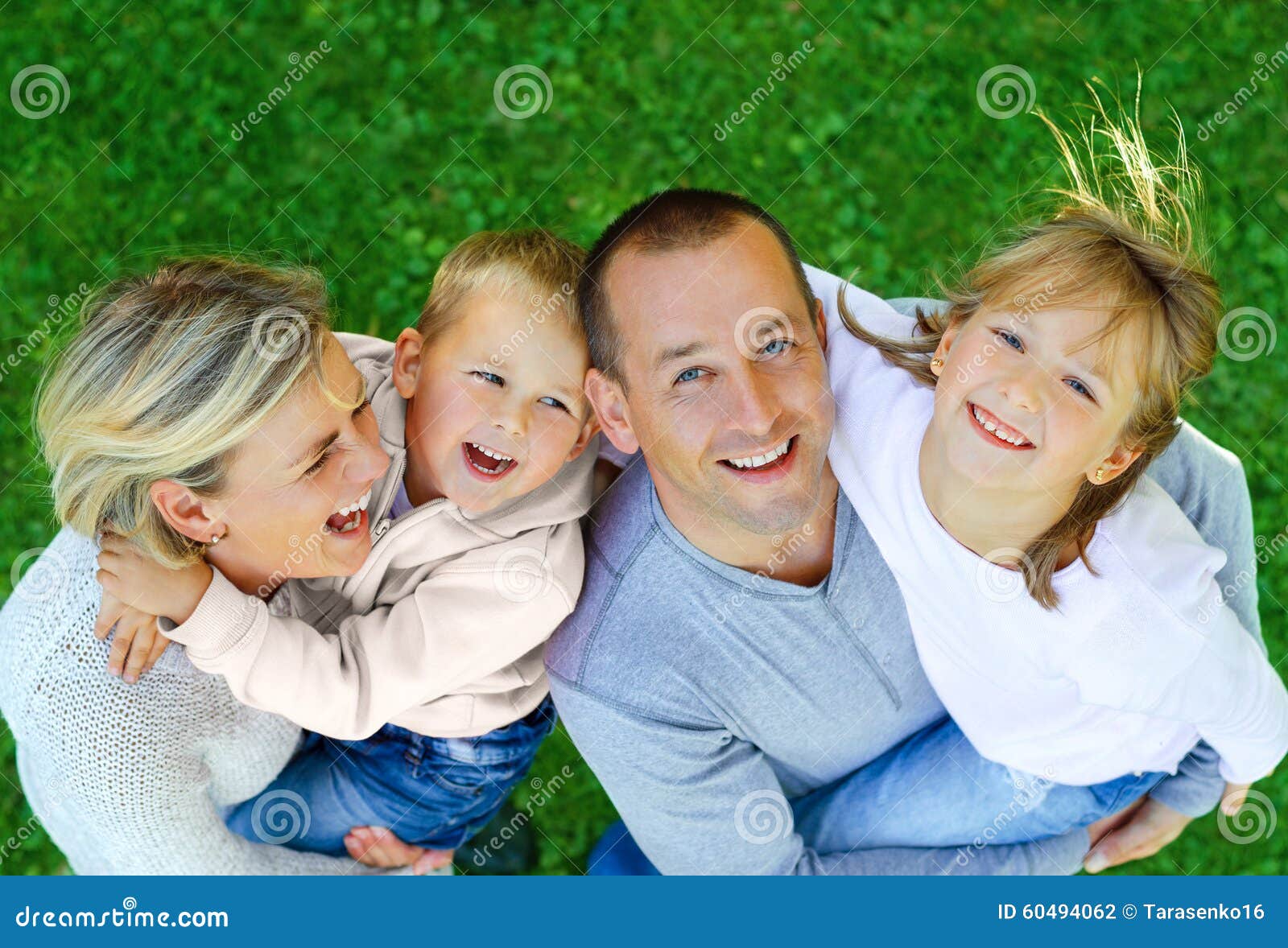 Happy Family on a Background of Grass Stock Photo - Image of horizontal ...