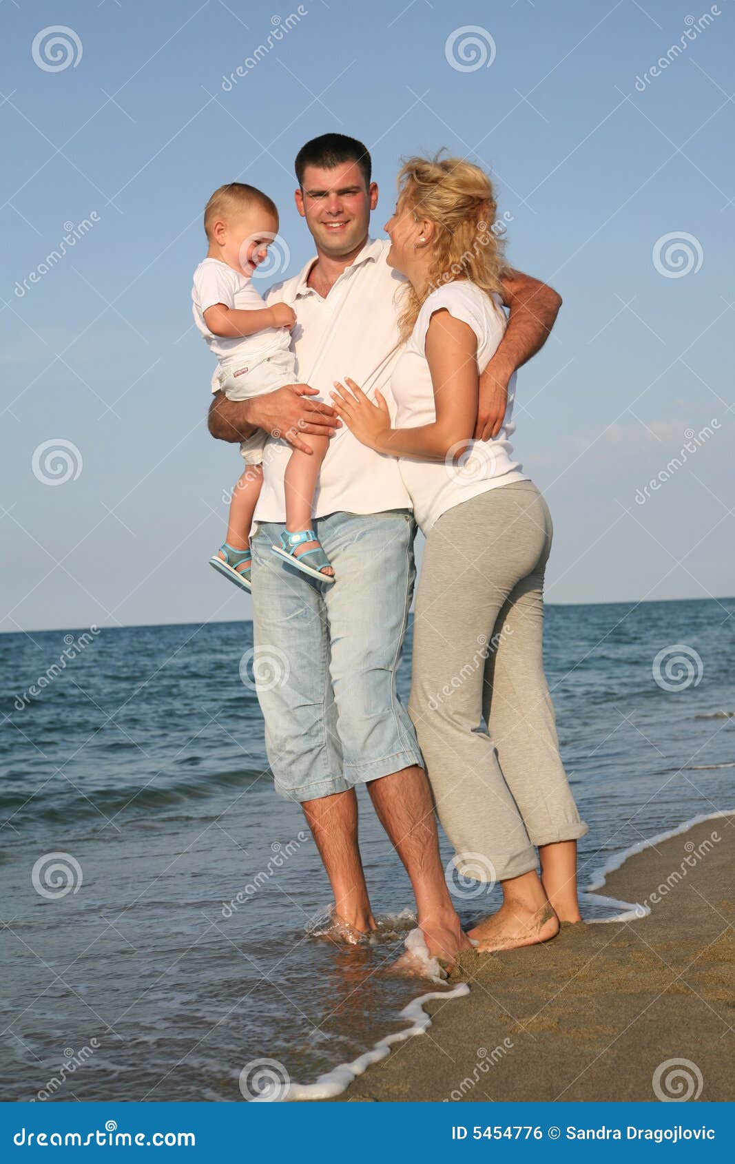 Happy family at the beach stock photo. Image of smiling - 5454776