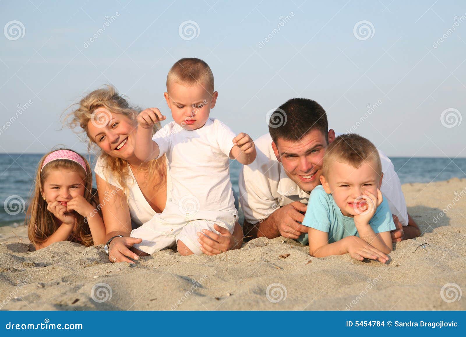 Happy family at the beach stock photo. Image of summer - 5454784