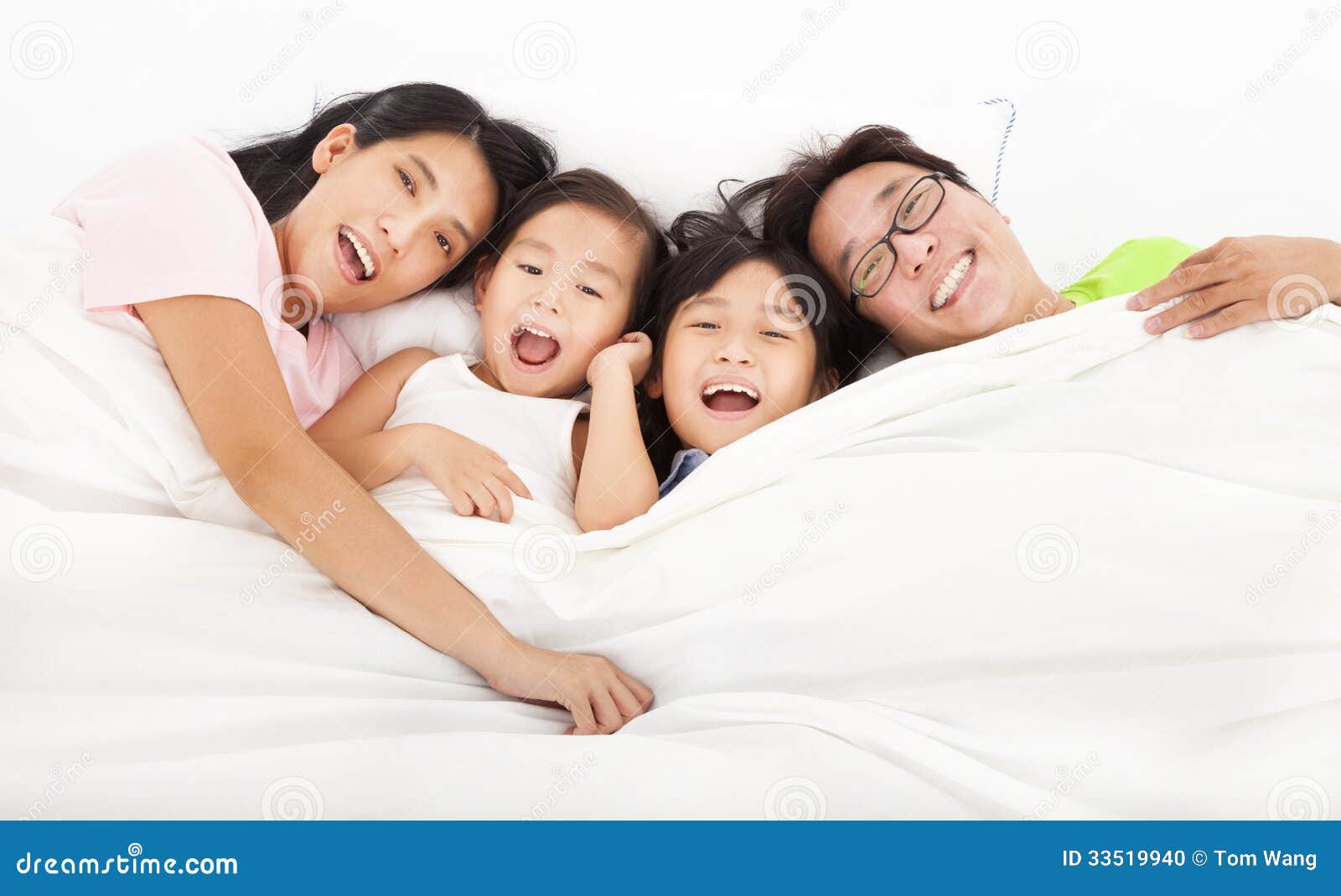 Happy family on the bed stock photo. Image of kids, casual - 33519940