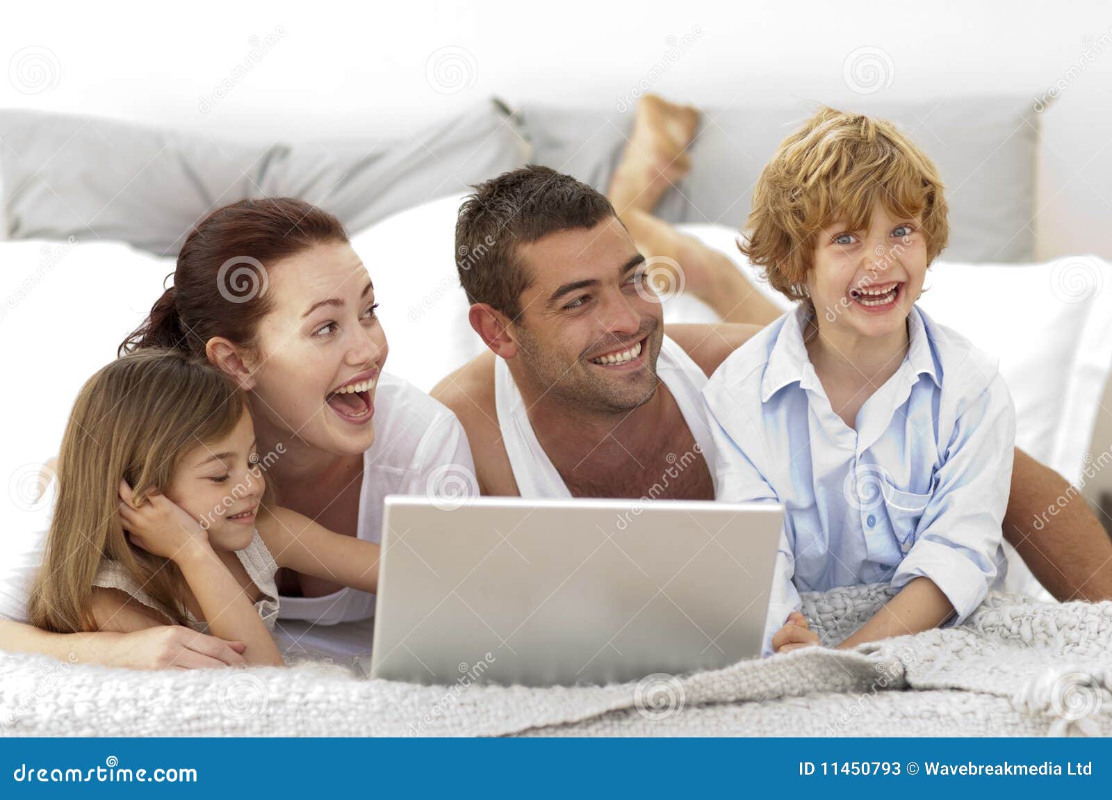 Happy Family in Bed Using a Laptop Stock Image - Image of internet ...