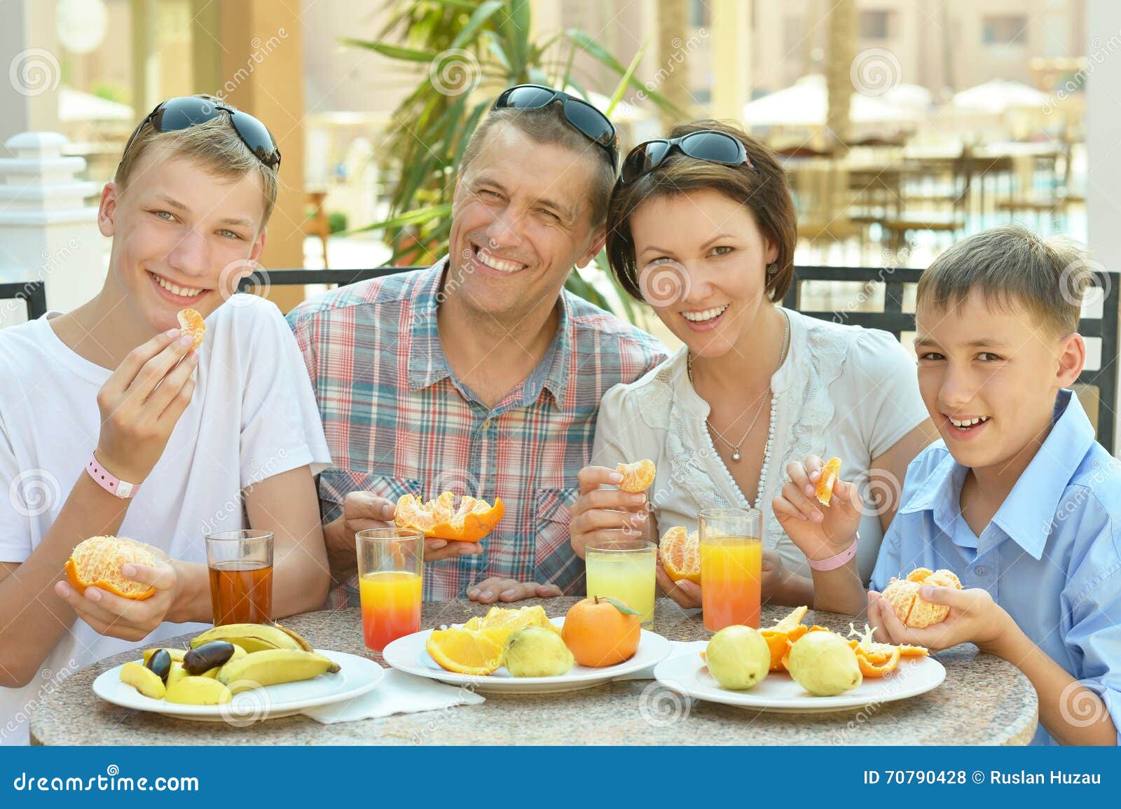 Happy family at breakfast stock photo. Image of father - 70790428