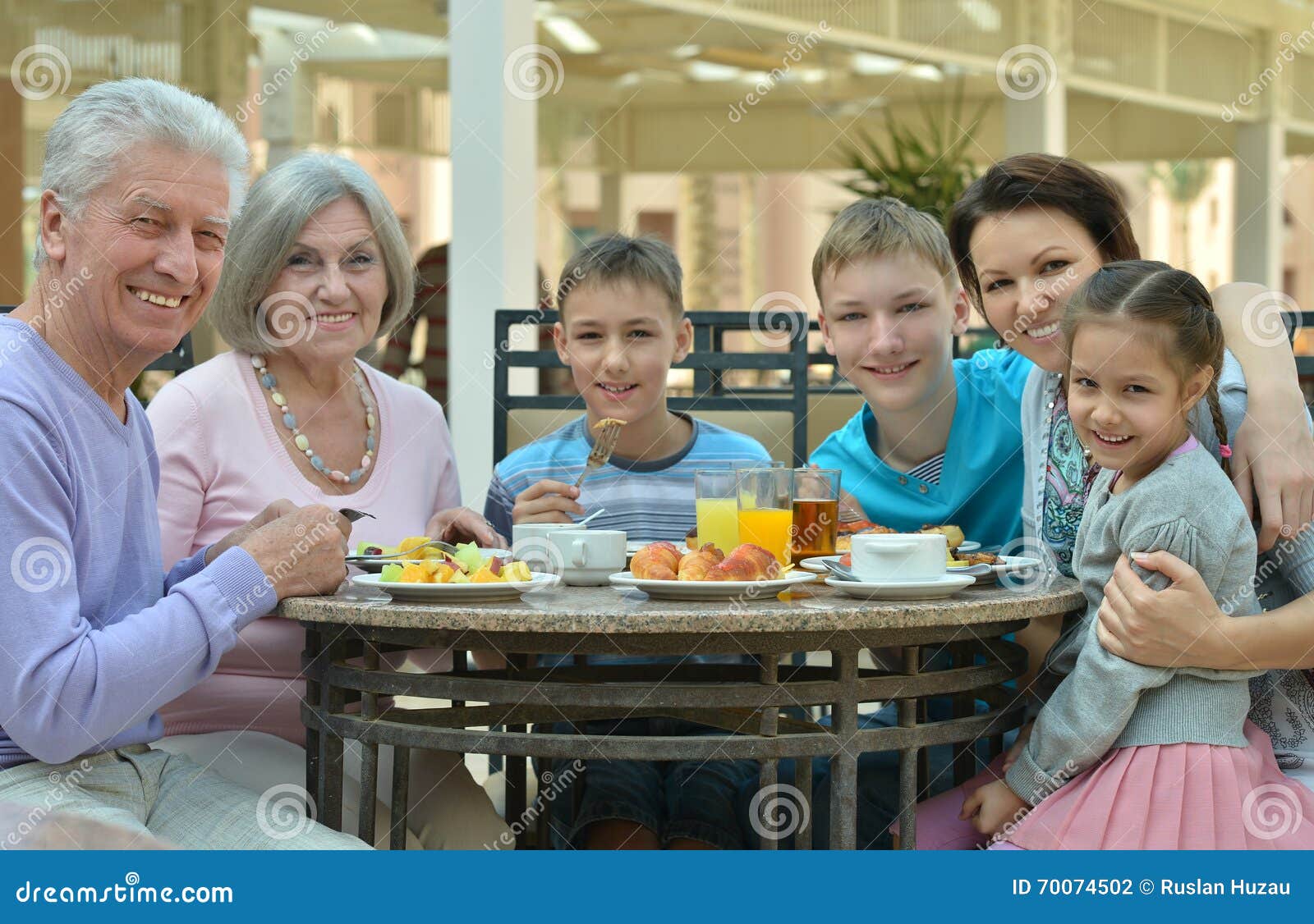 Happy family at breakfast stock photo. Image of relax - 70074502