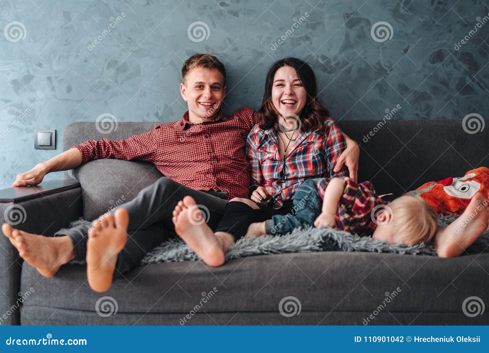 Happy family on the couch stock photo. Image of home - 110901042