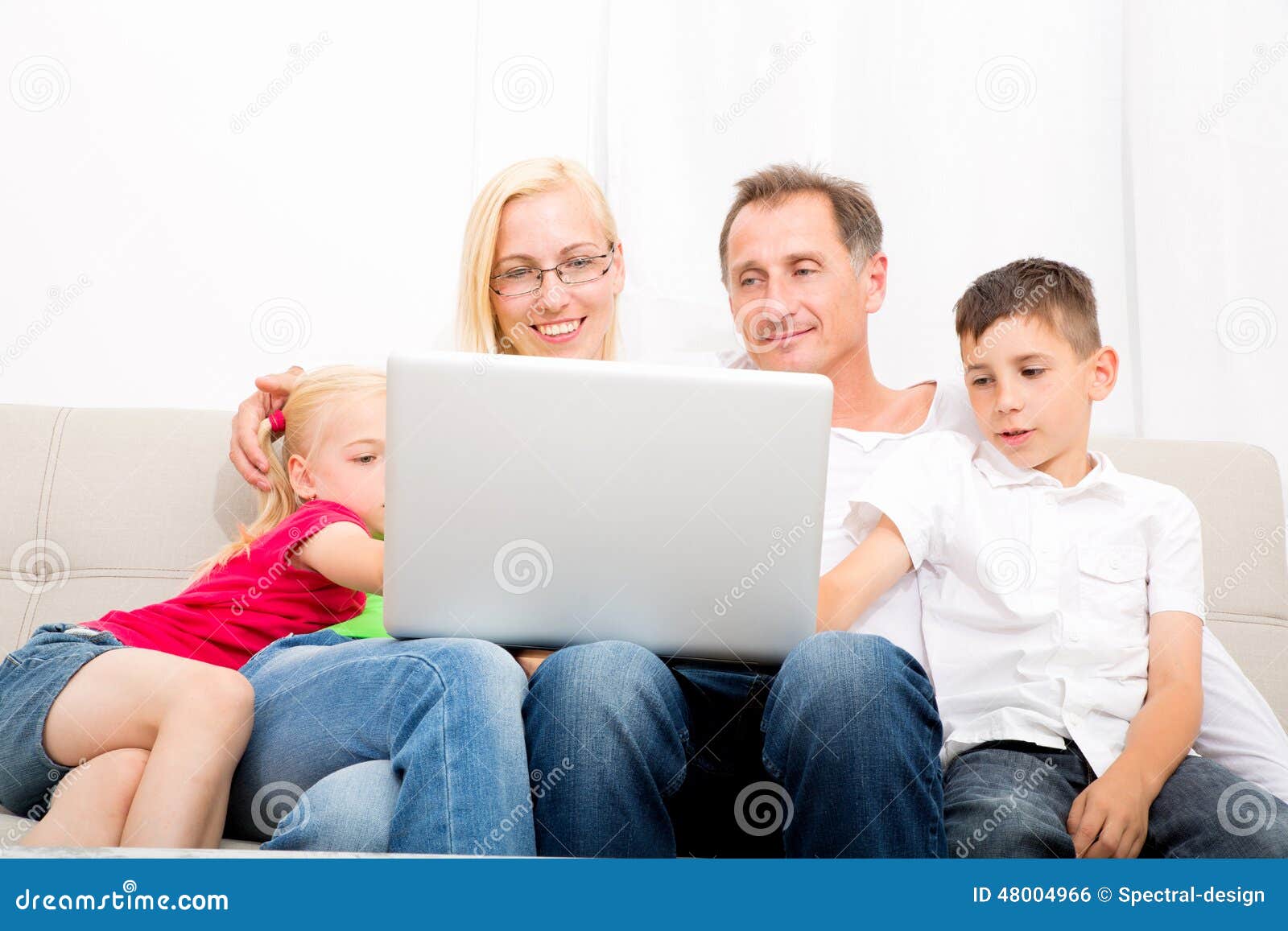 Happy family on the couch stock photo. Image of people - 48004966