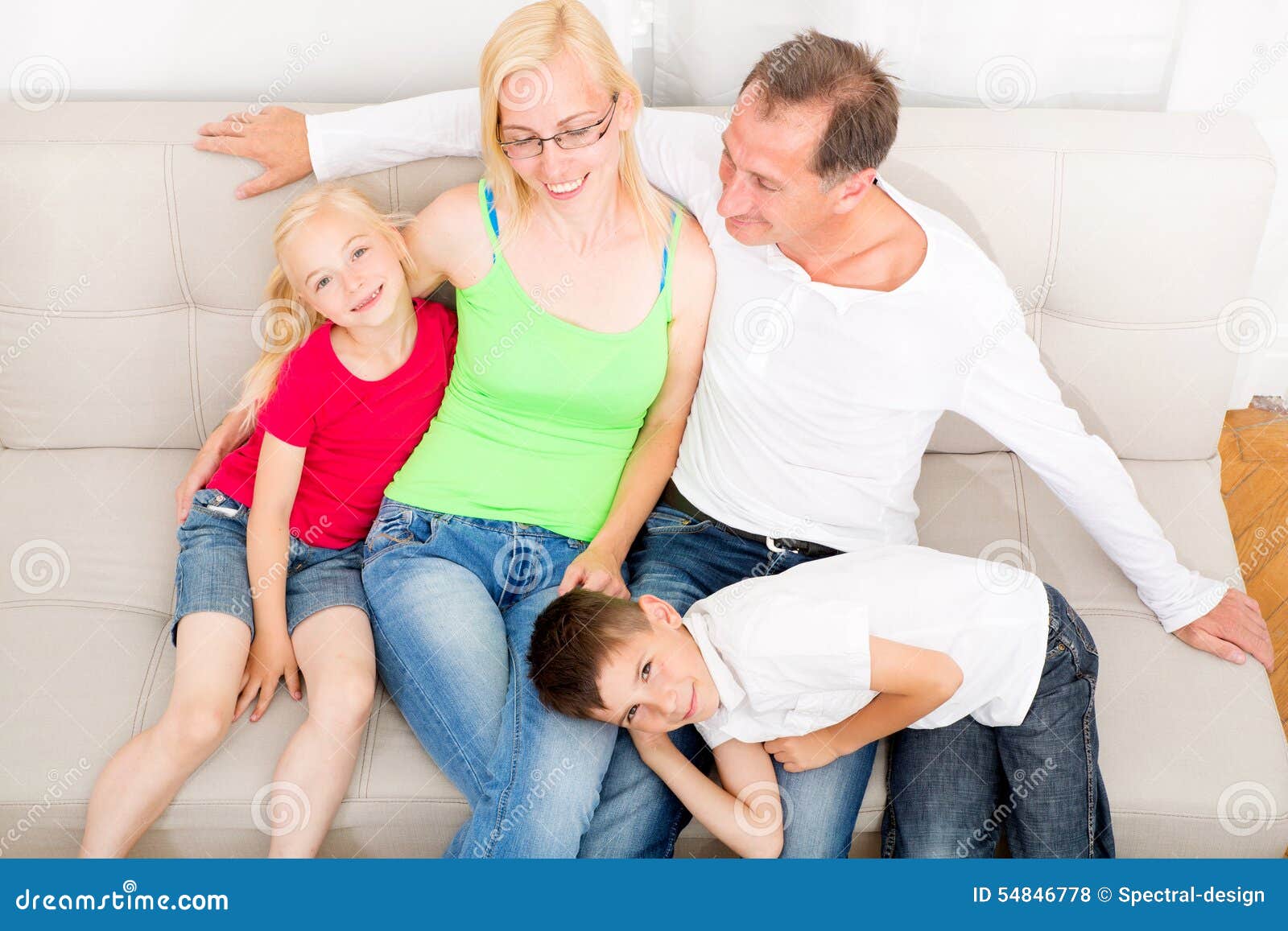 Happy family on the couch stock photo. Image of daughter - 54846778