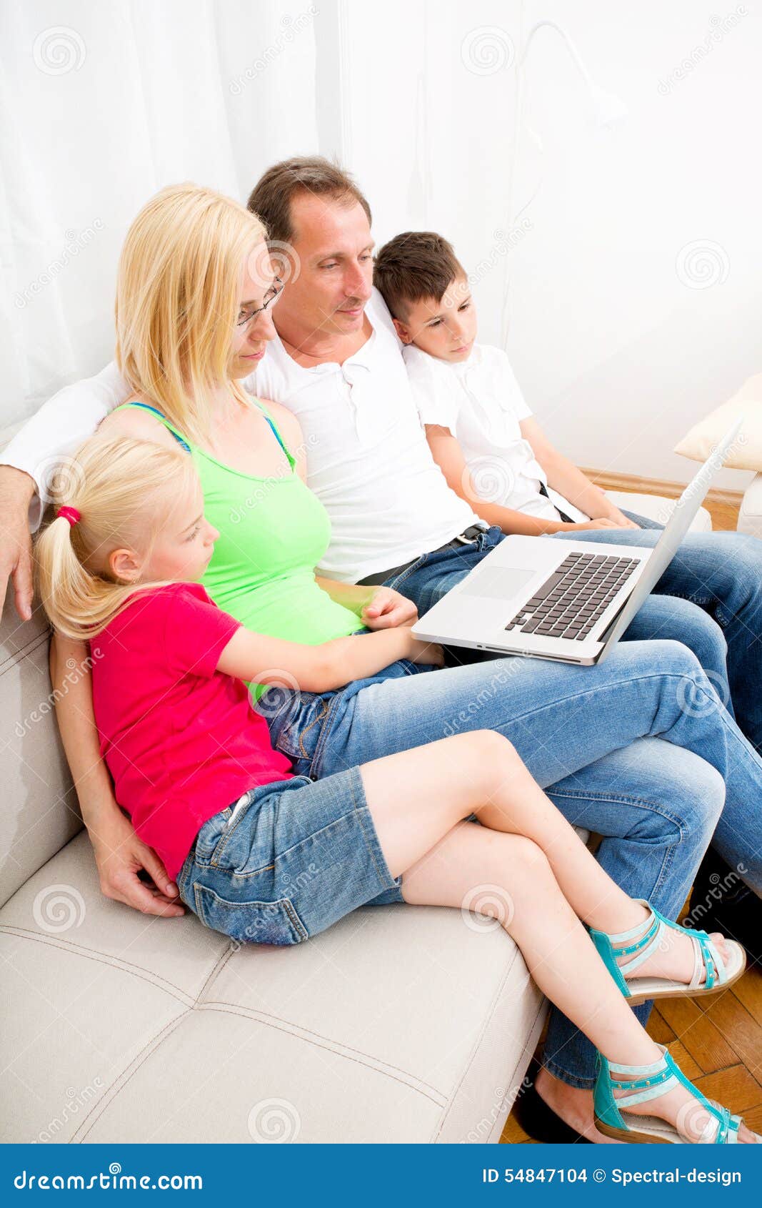 Happy family on the couch stock photo. Image of indoors - 54847104