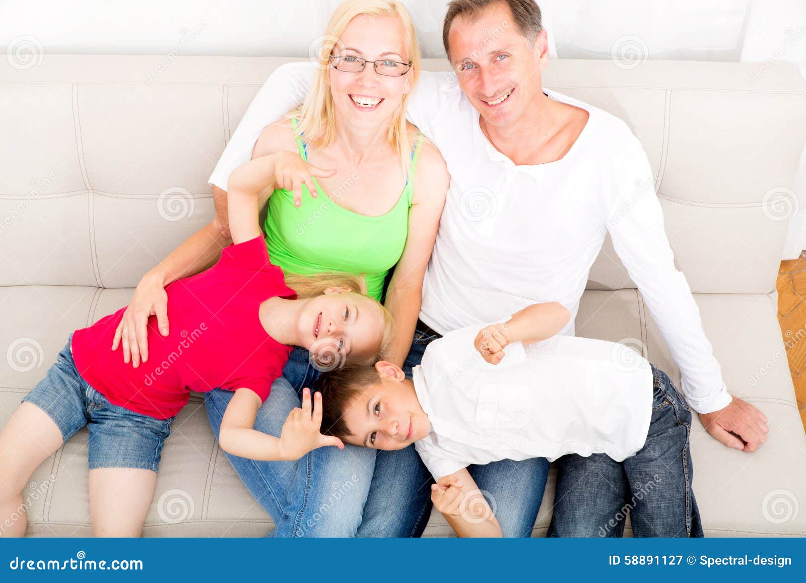 Happy family on the couch stock image. Image of girl - 58891127