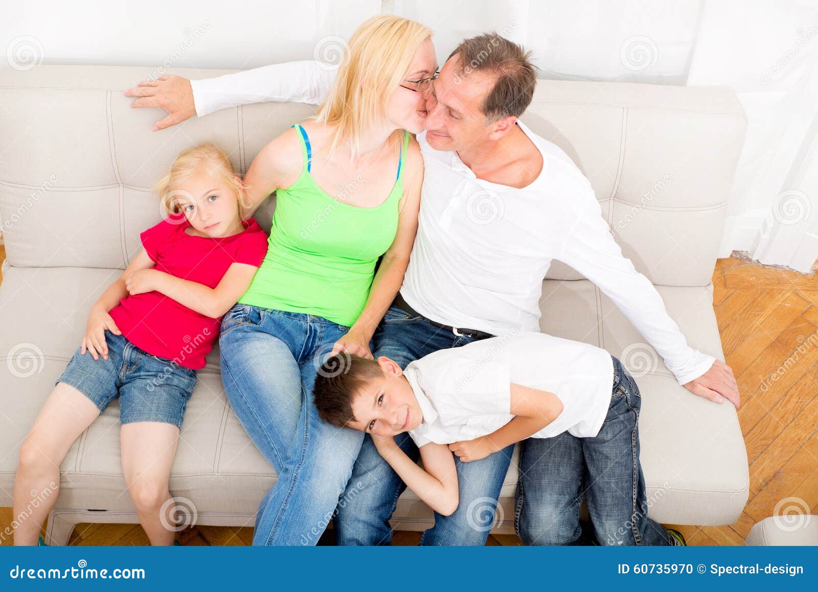 Happy family on the couch stock photo. Image of affection - 60735970