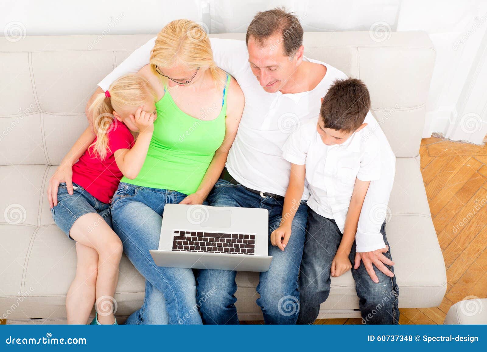 Happy family on the couch stock photo. Image of female - 60737348
