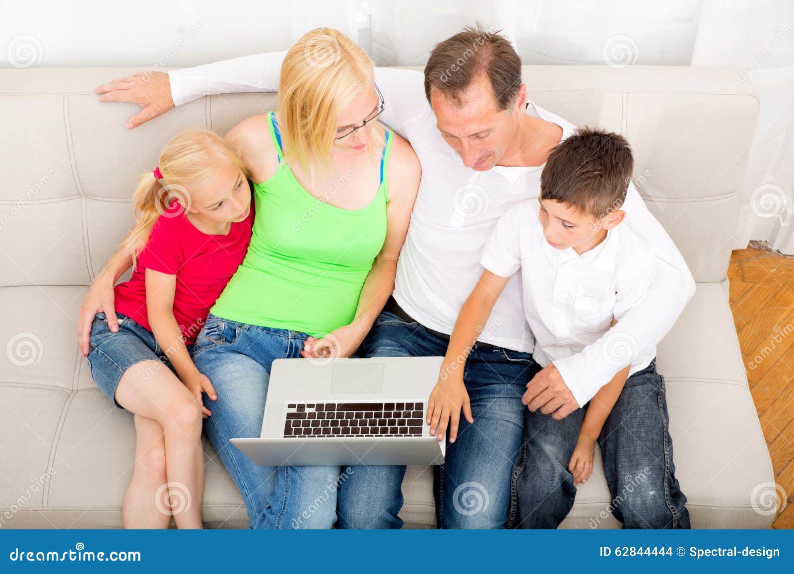Happy family on the couch stock photo. Image of couch - 62844444