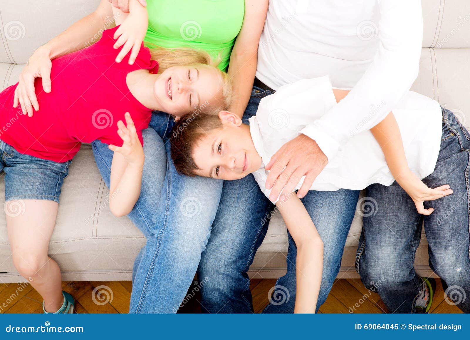 Happy family on the couch stock image. Image of home - 69064045
