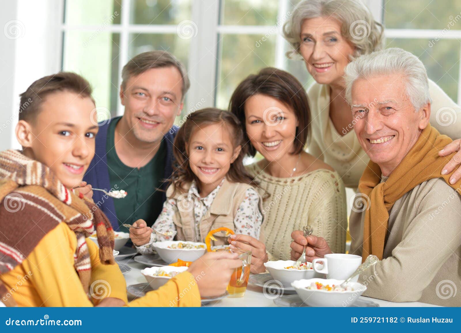Happy Family of Different Generations Eating Together Stock Photo ...