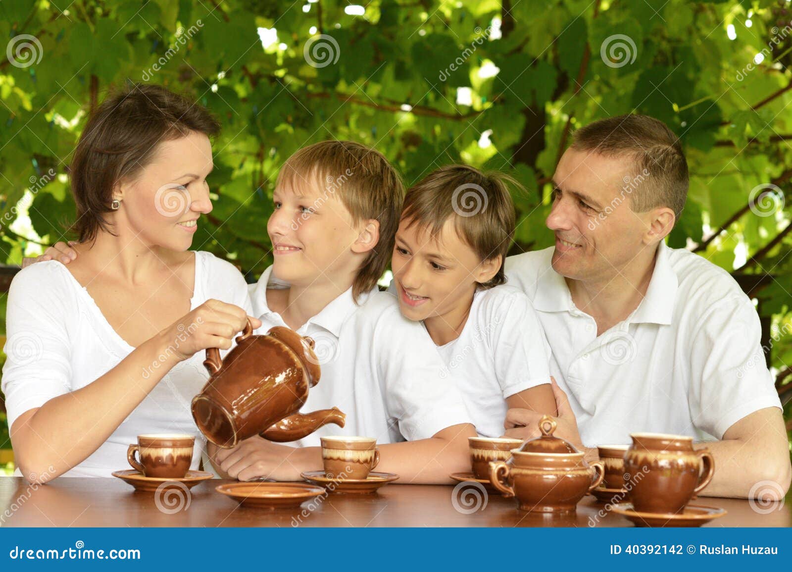 Happy family drinking tea stock photo. Image of colors - 40392142