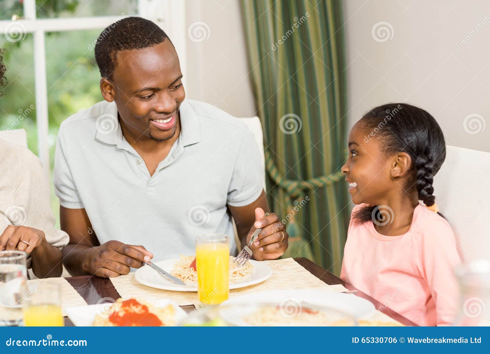 Happy Family Enjoying Their Meal Stock Photo - Image of parents, home ...