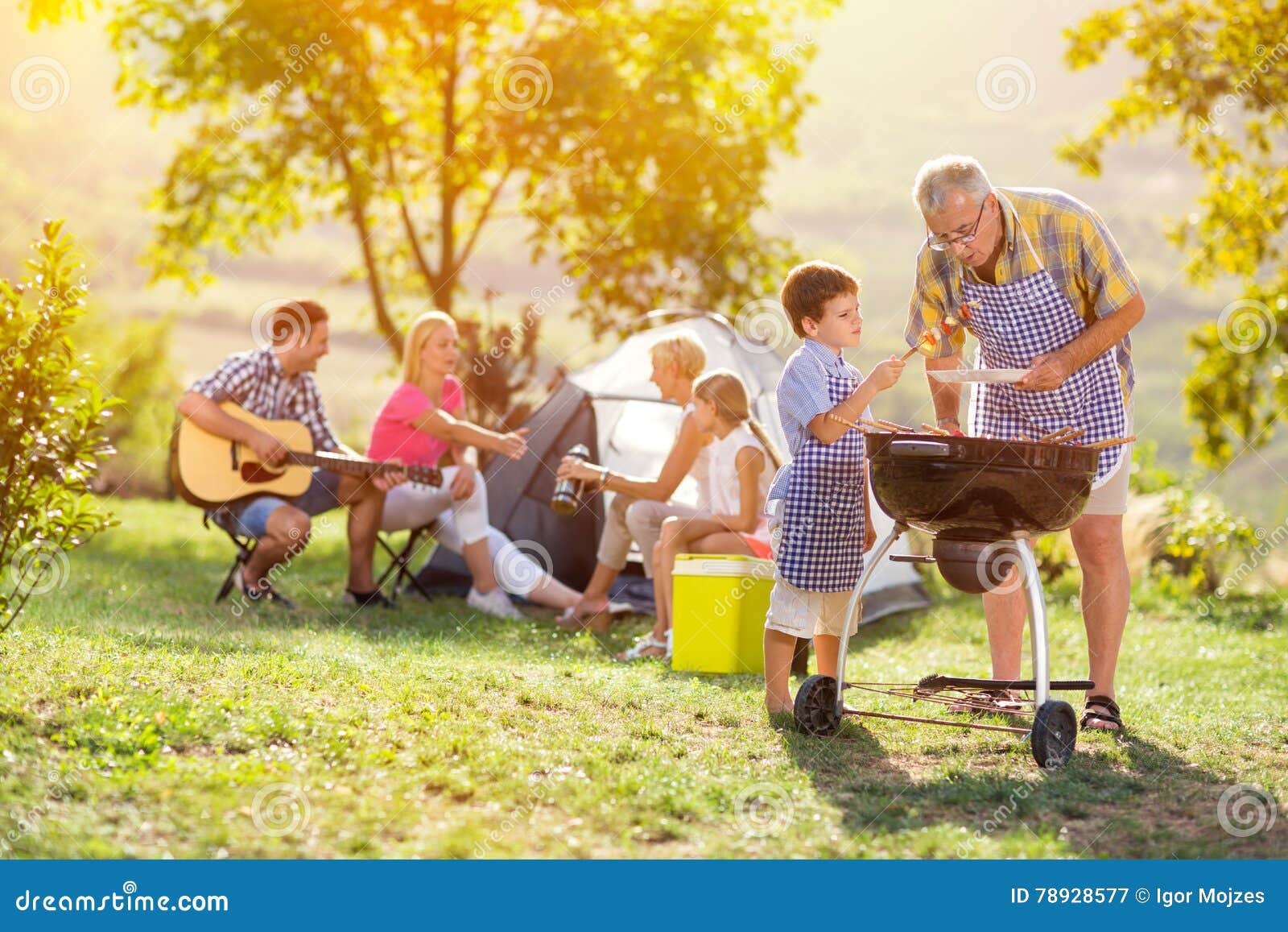 Happy family grilling meat stock image. Image of forest - 78928577