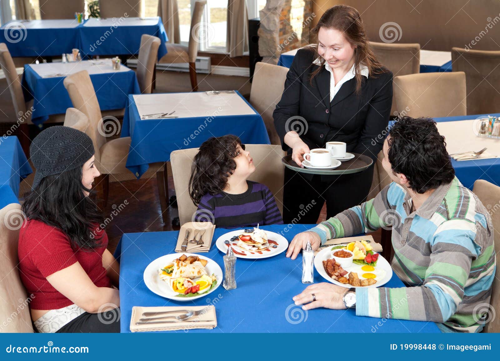 Happy Family Having Breakfast at a Restaurant Stock Photo - Image of ...