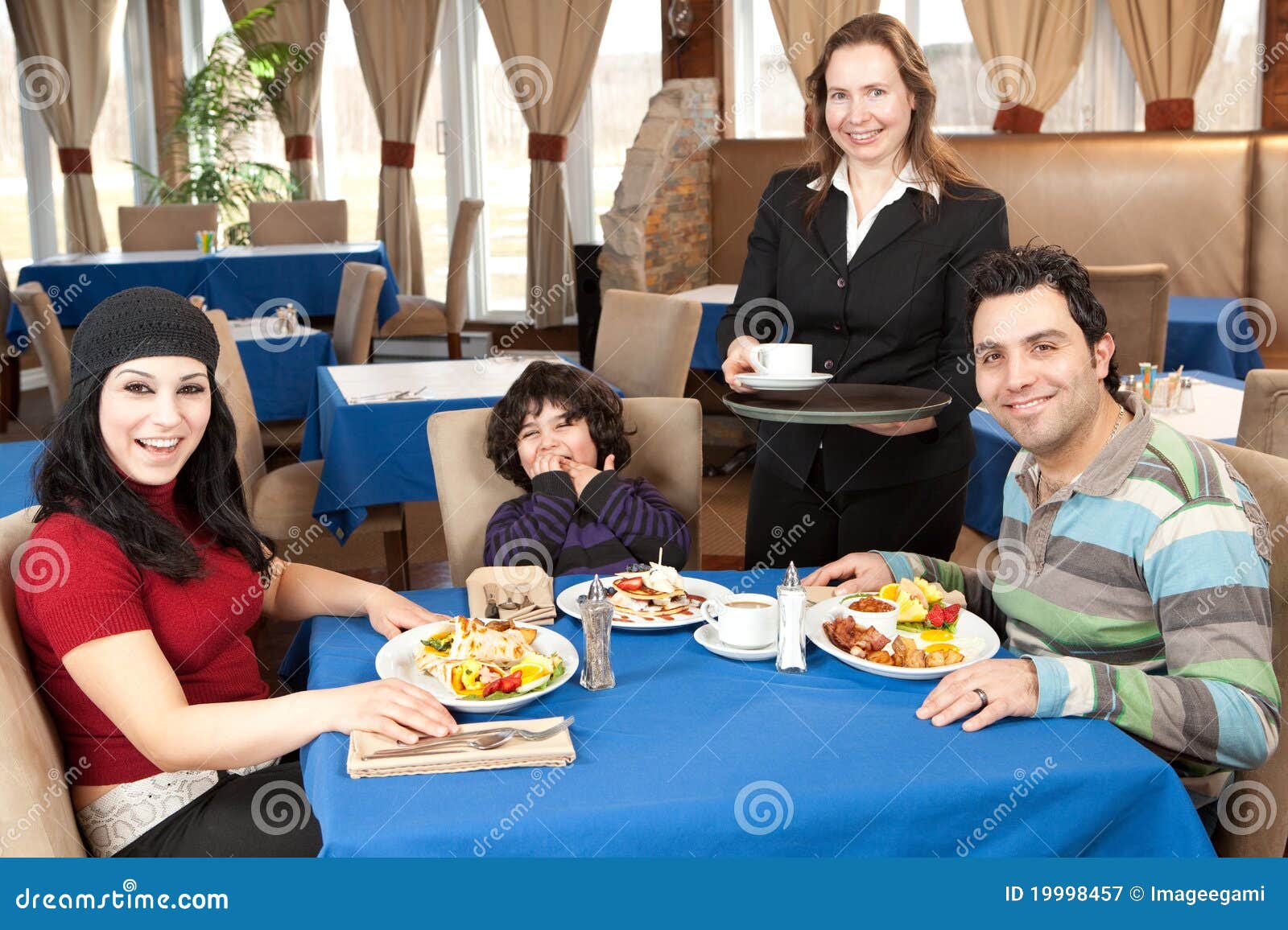 Happy Family Having Breakfast at a Restaurant Stock Image - Image of ...