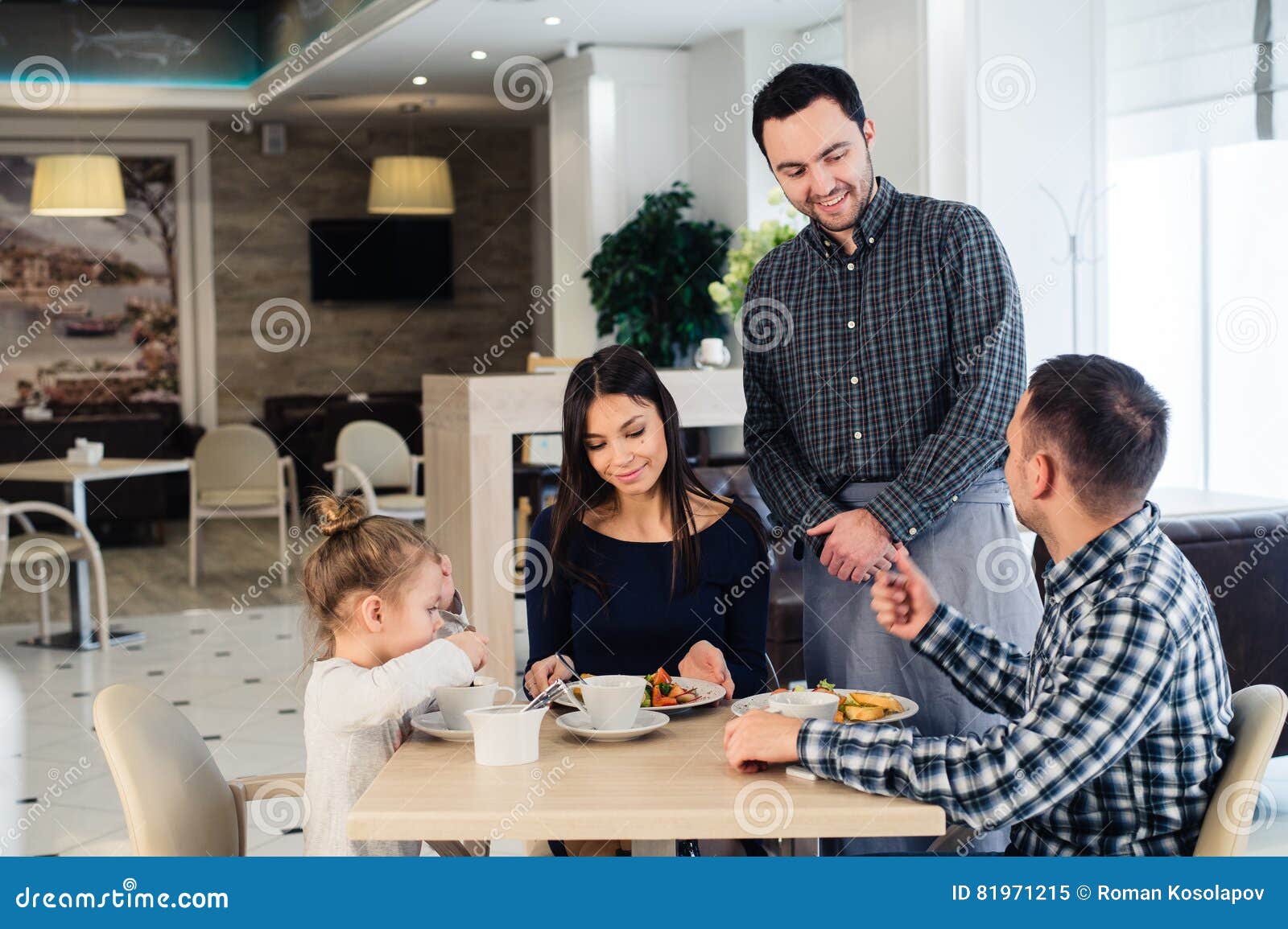 Happy Family Having Breakfast at a Restaurant Stock Image - Image of ...
