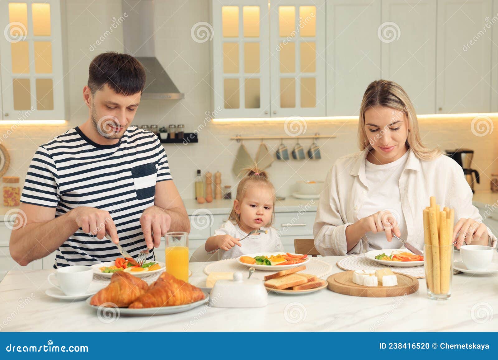 Happy Family Having Breakfast Together at Table in Kitchen Stock Photo ...