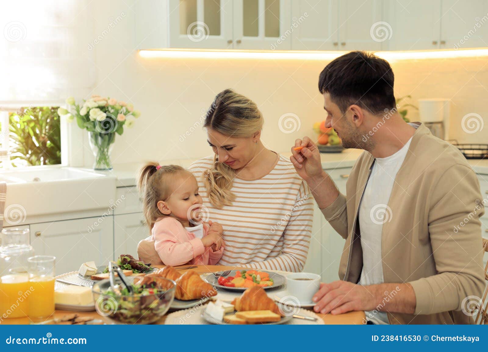 Happy Family Having Breakfast Together at Table in Kitchen Stock Photo ...