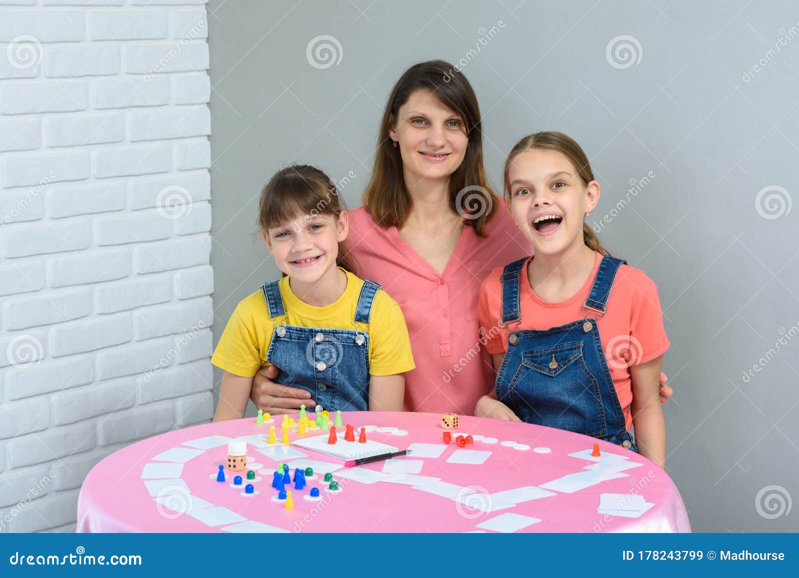 Happy Family Having Fun Laughing while Playing Board Games at a Table ...