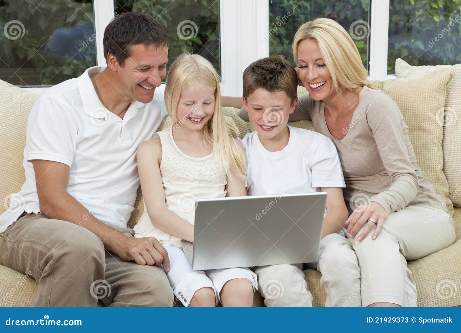 Happy Family Having Fun Using a Computer at Home Stock Image - Image of ...