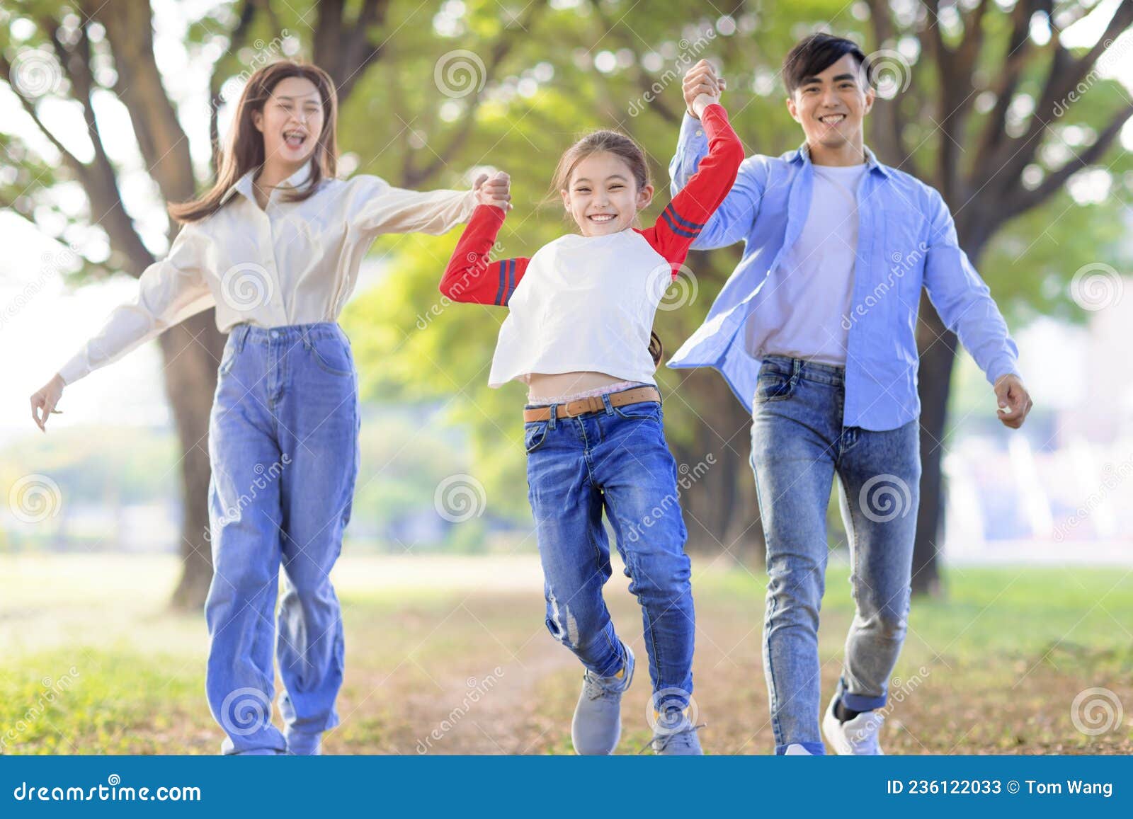 Happy Family Jumping and Playing Together in the Park Stock Image ...