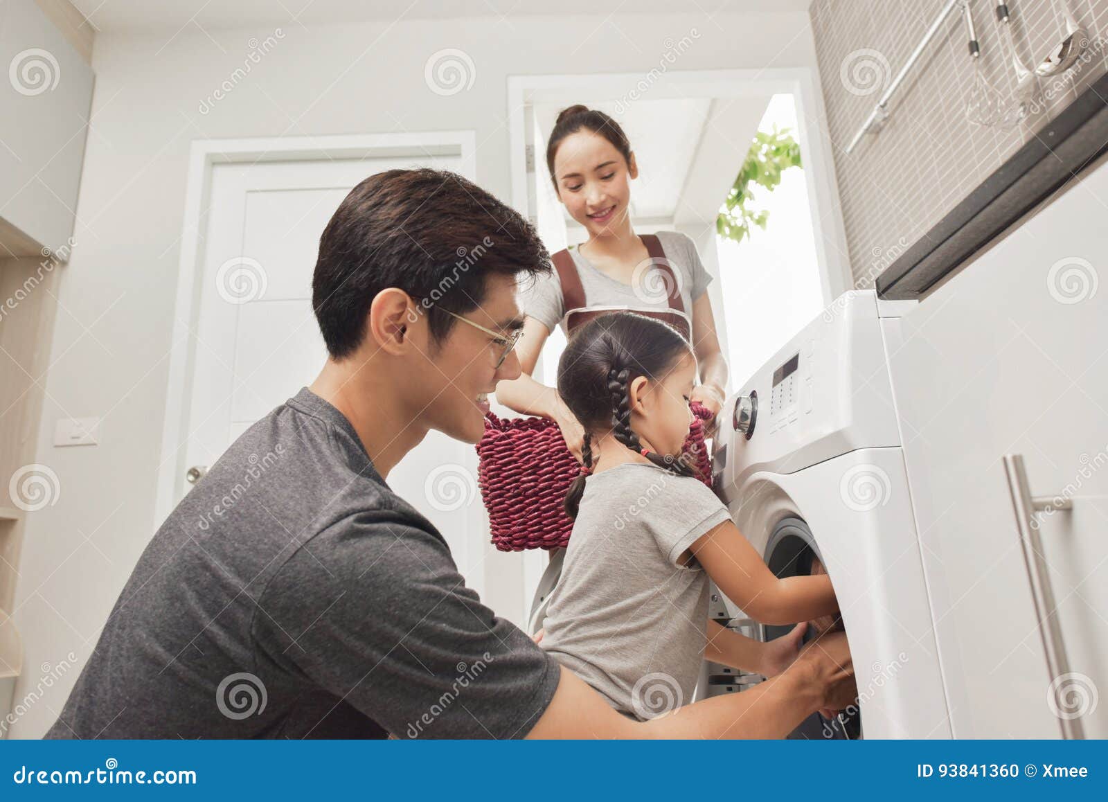 Happy Family Loading Clothes into Washing Machine in Home Stock Photo ...