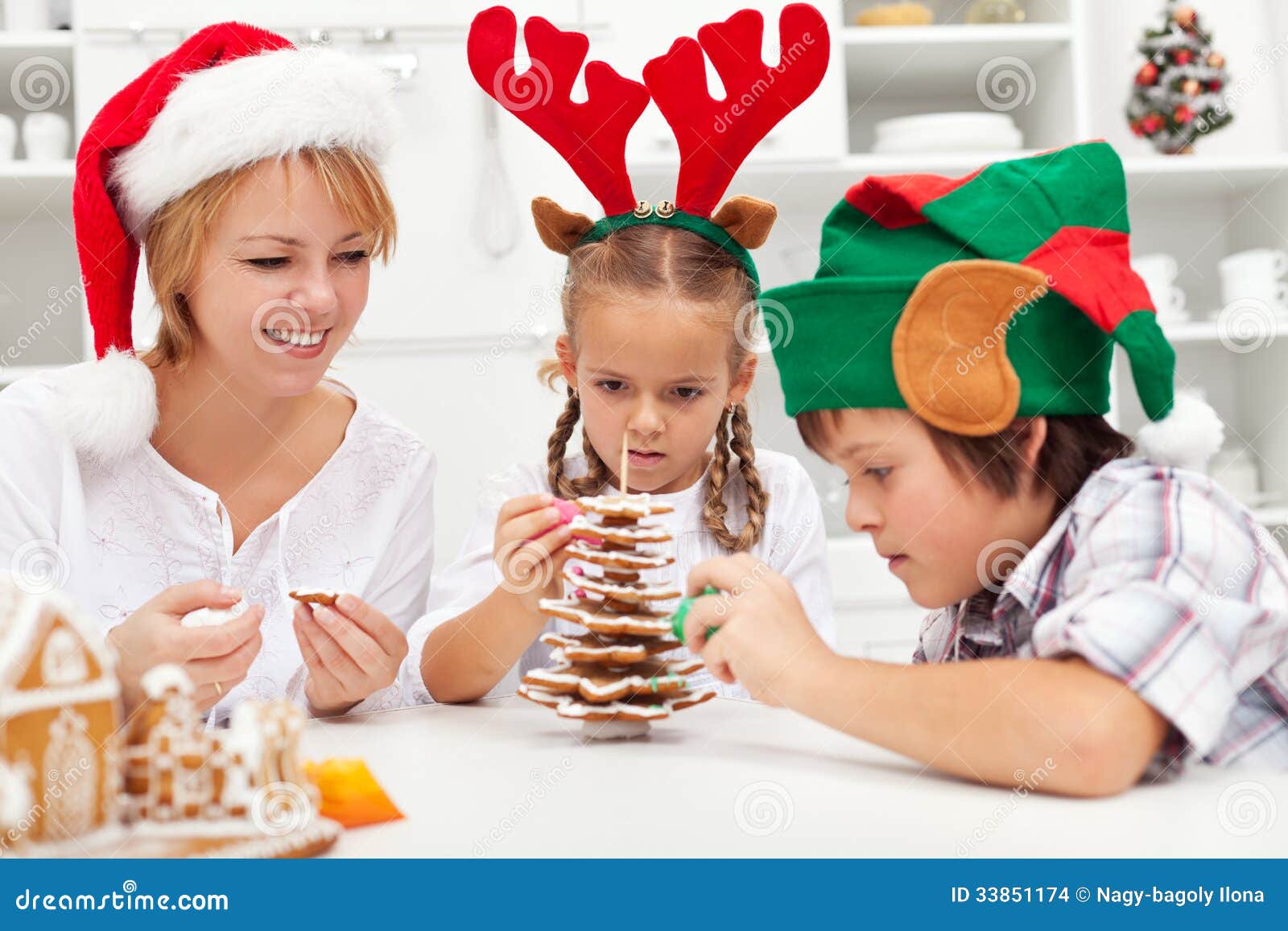 Happy Family Making a Gingerbread Cookie Christmas Tree Stock Photo ...