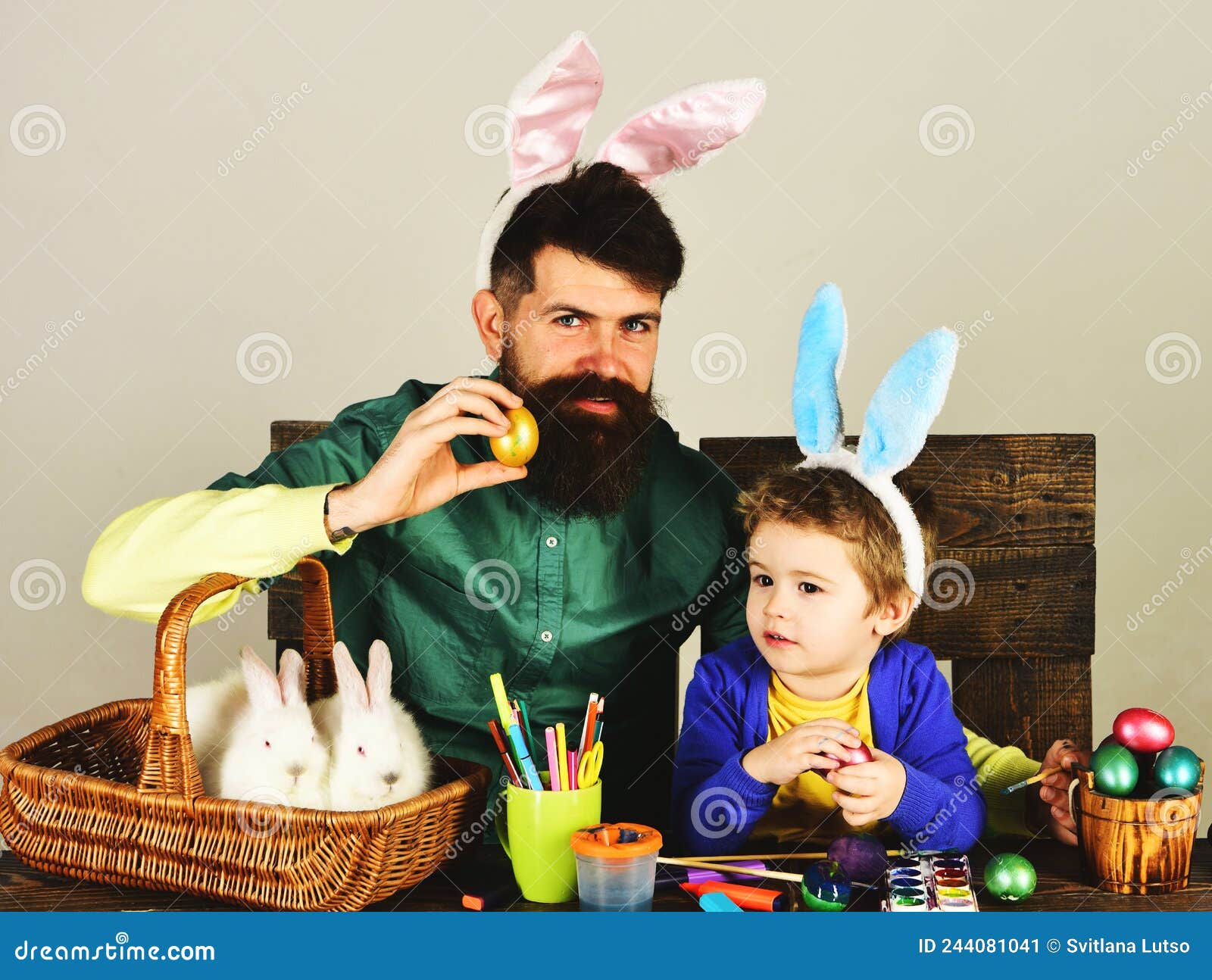 Happy Family with Painted Easter Eggs. Father and Son in Bunny Ears ...