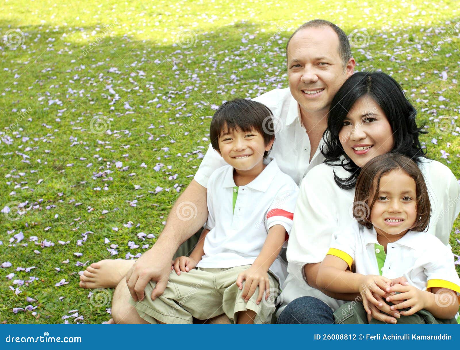 Happy family in the park stock photo. Image of grass - 26008812