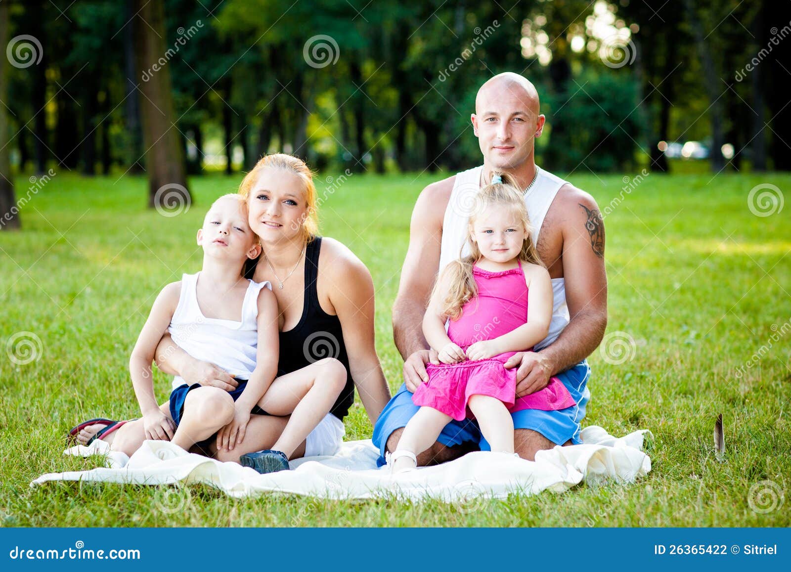 Happy family in a park stock photo. Image of smiling - 26365422