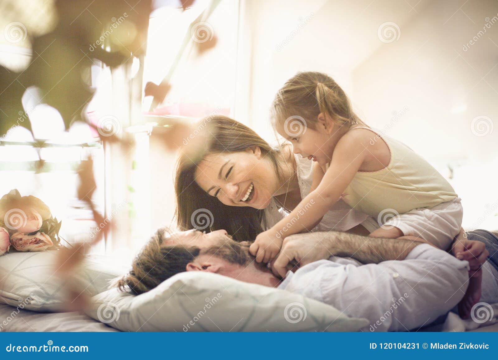 Happy conversation in bed. stock image. Image of bedroom - 120104231