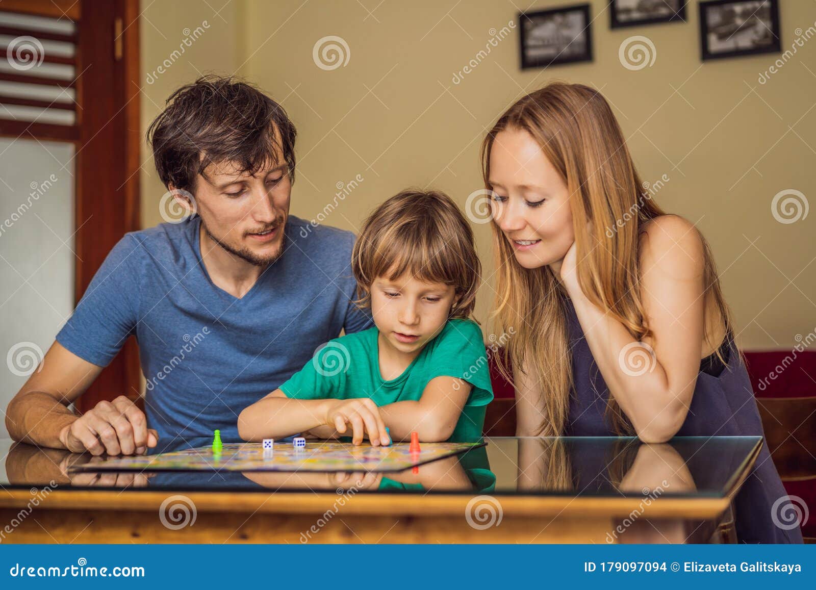 Happy Family Playing Board Game at Home Stock Photo - Image of floor ...