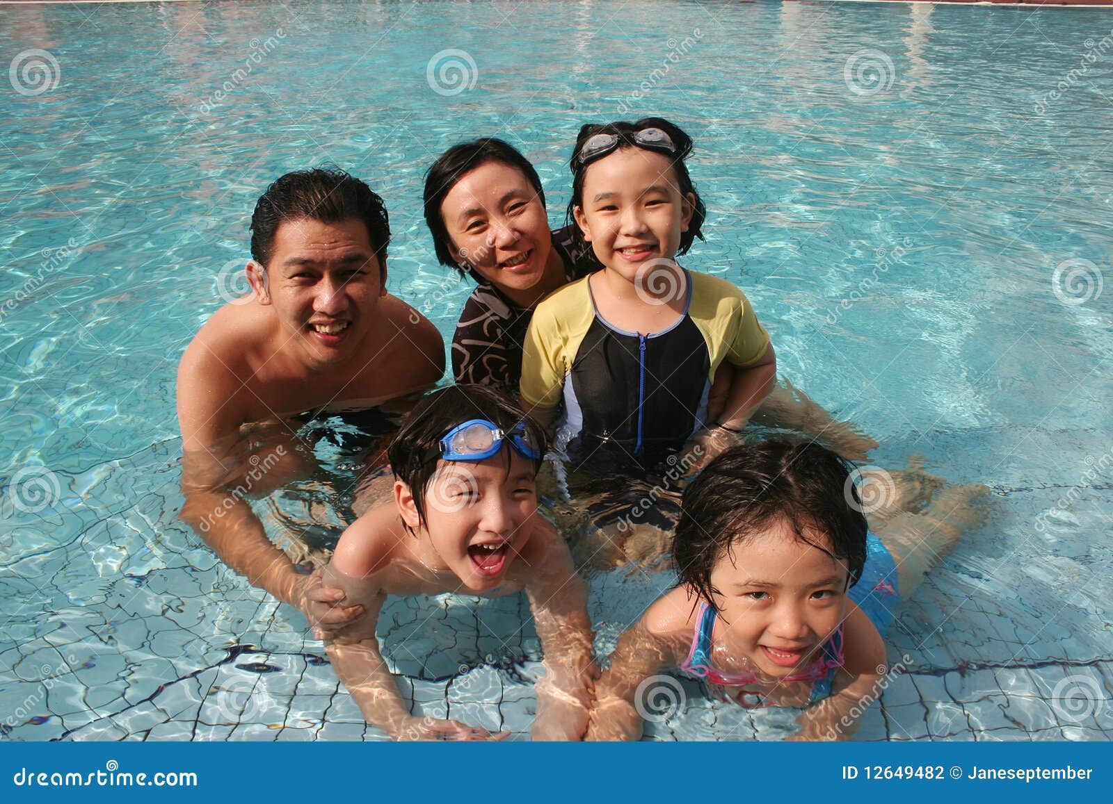 Happy family in the pool stock photo. Image of asian - 12649482