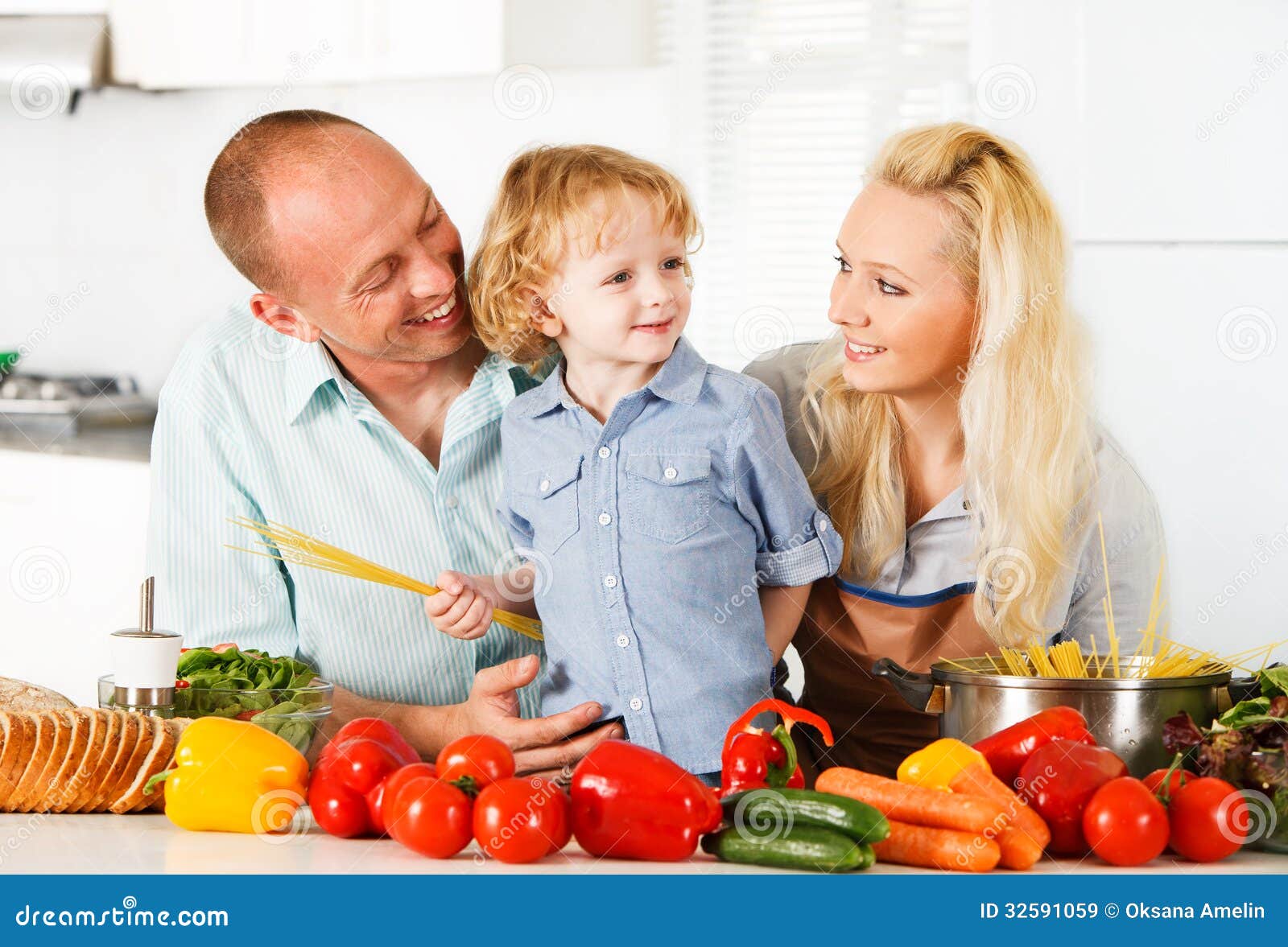 Happy Family Preparing a Healthy Dinner at Home. Stock Image - Image of ...