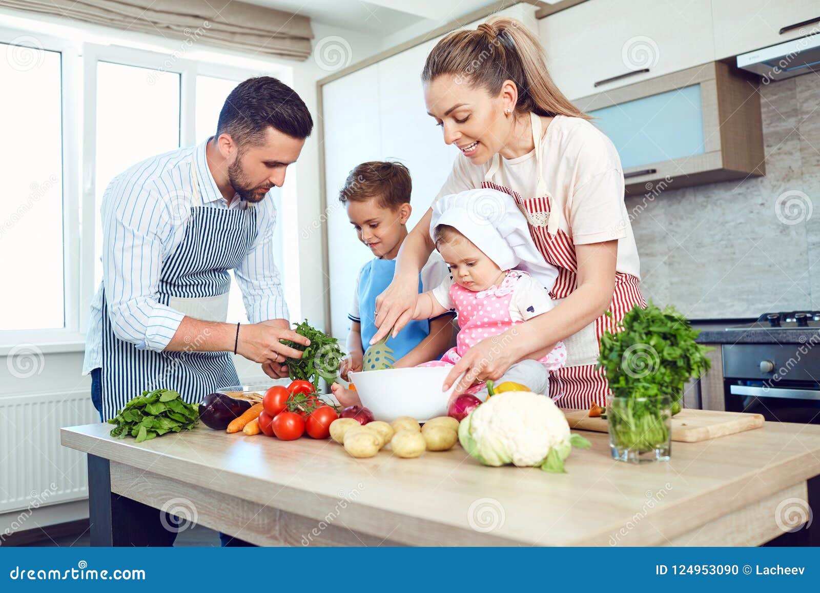 A Happy Family is Preparing in the Kitchen. Stock Photo - Image of ...